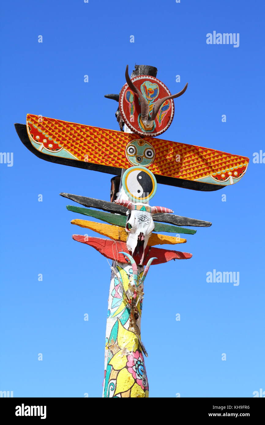 A colorful decorated totem column signaling one's grave on the beach ...