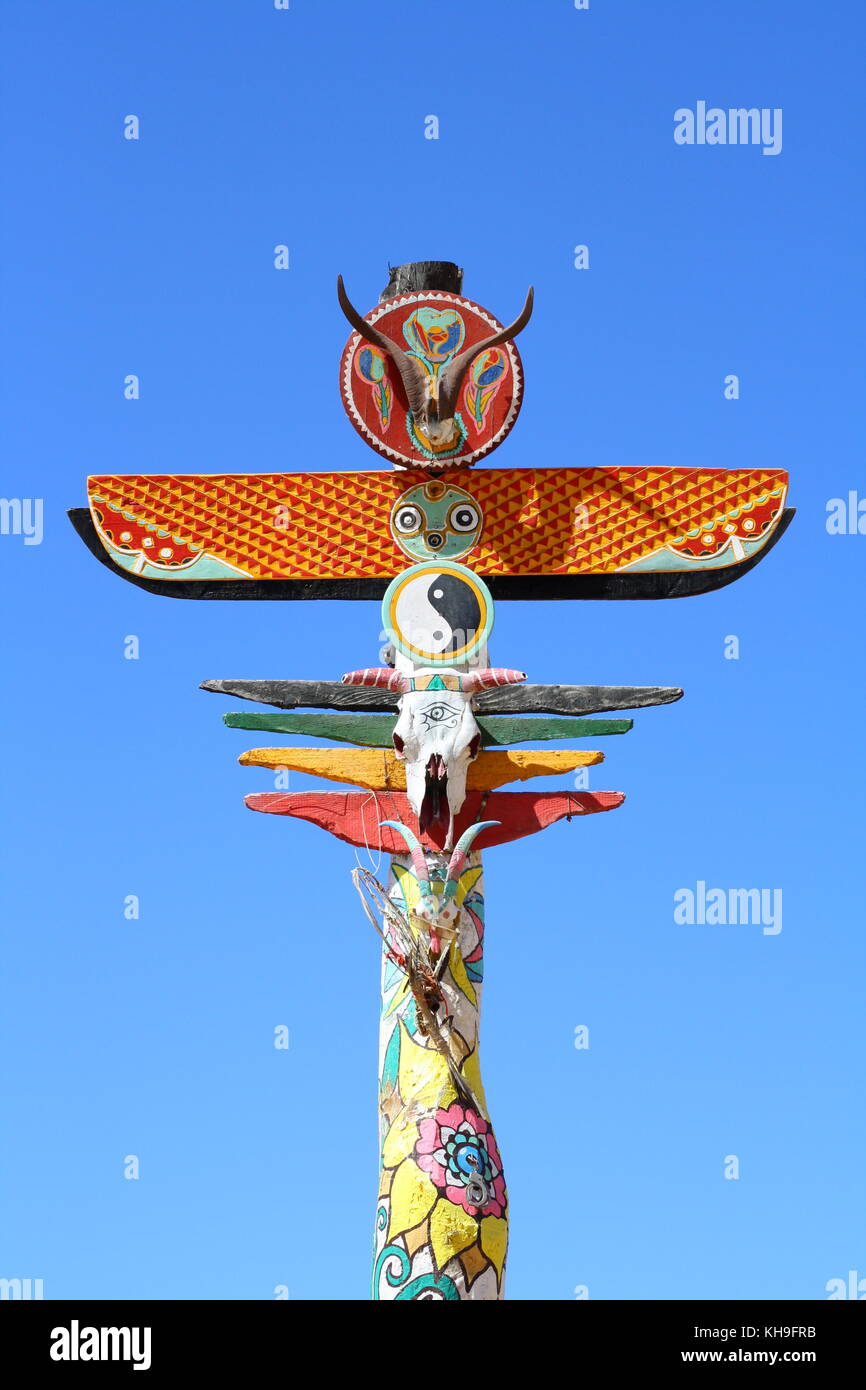 A colorful decorated totem column signaling one's grave on the beach ...
