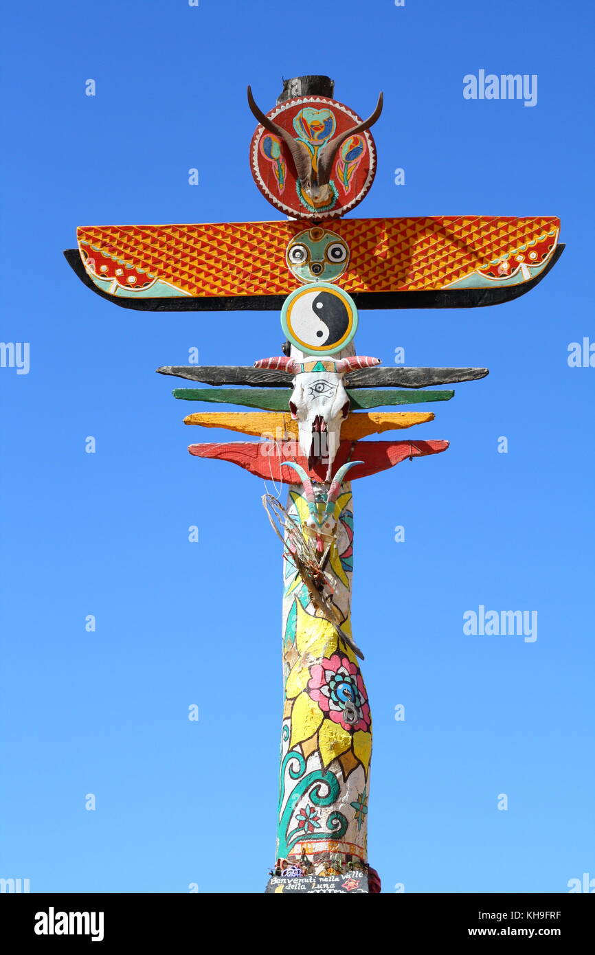 A colorful decorated totem column signaling one's grave on the beach ...