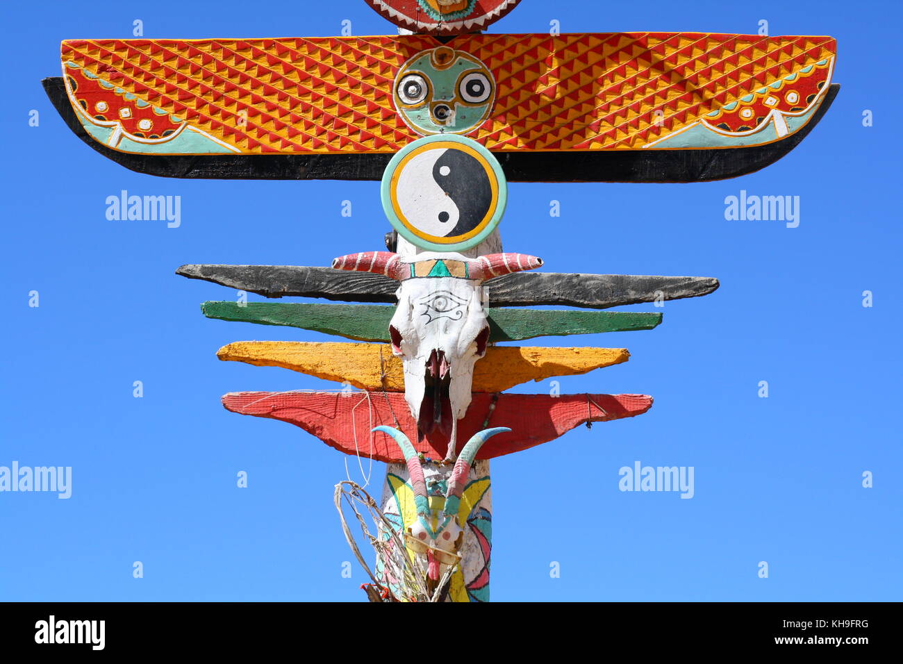 A colorful decorated totem column signaling one's grave on the beach ...