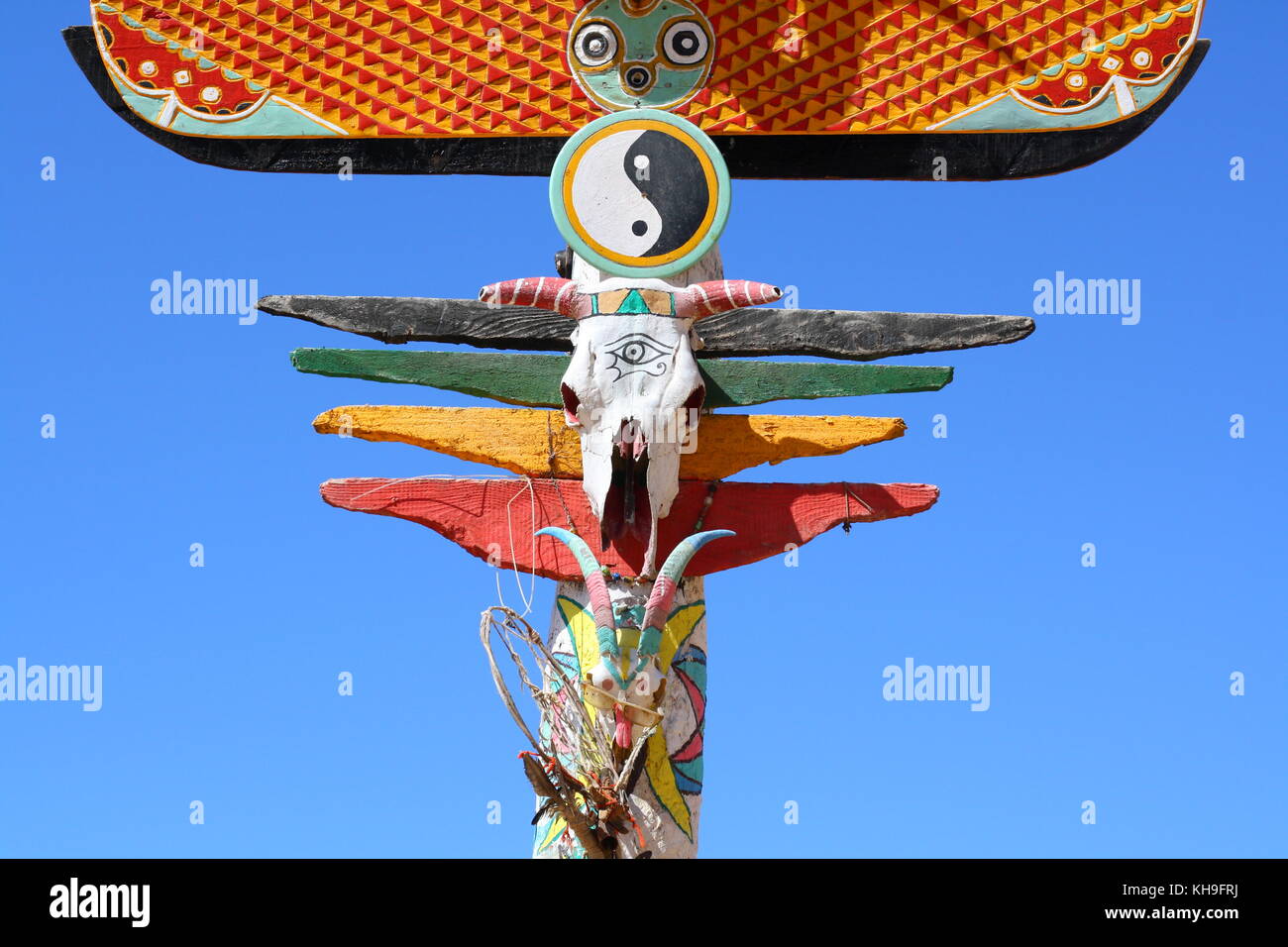 A colorful decorated totem column signaling one's grave on the beach ...