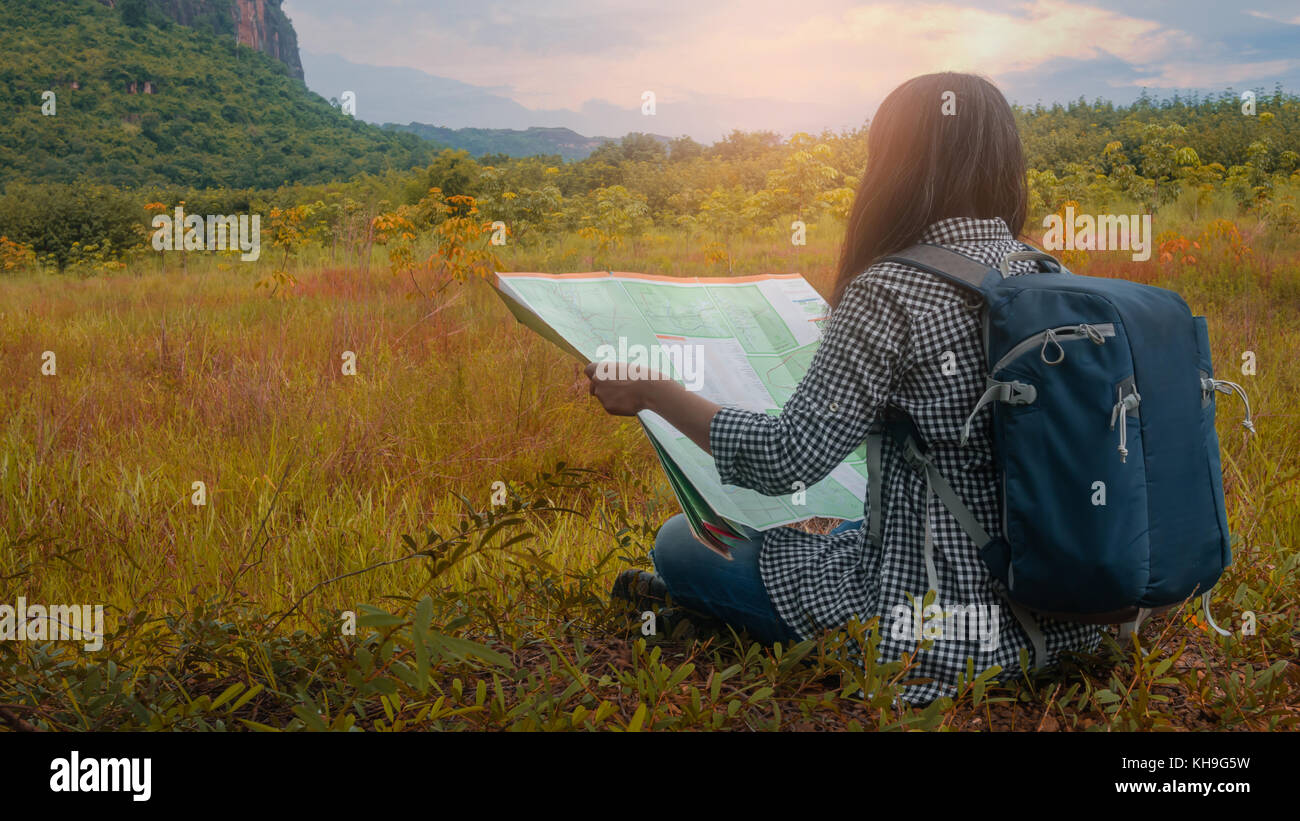 Hipster Asian woman backpacker look map on trip Stock Photo - Alamy