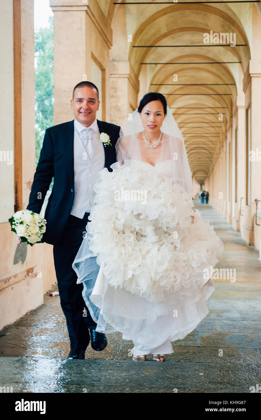 Interracial wedding at Bologna, Italy. Happy chineese bride and ...