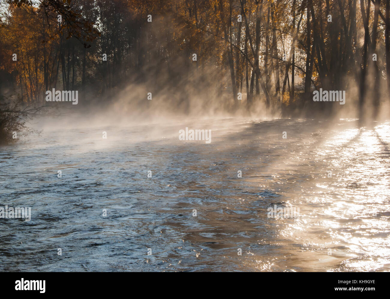 Mist rising from the river on a cool autumn morning creating a fairy ...