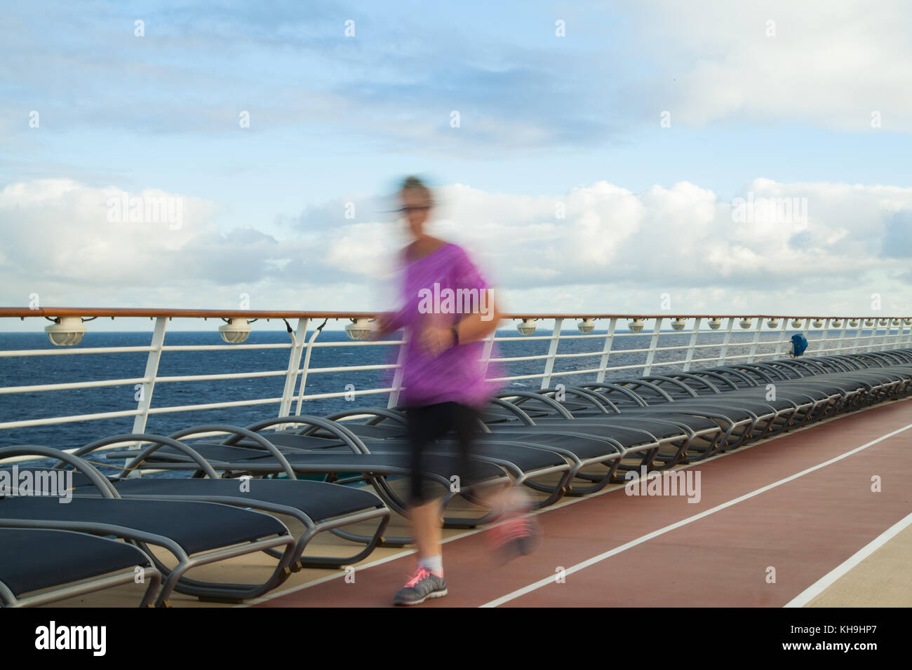 Blurred Joggers on cruise ship running track Stock Photo - Alamy