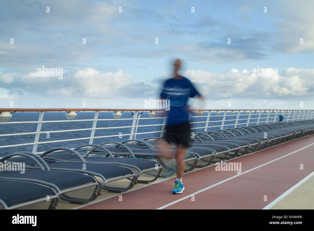 Blurred Joggers on cruise ship running track Stock Photo - Alamy