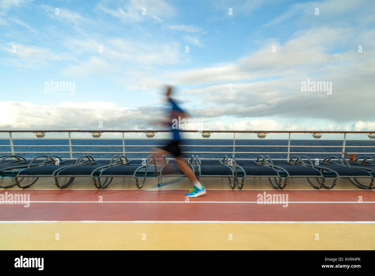 Blurred Joggers on cruise ship running track Stock Photo - Alamy