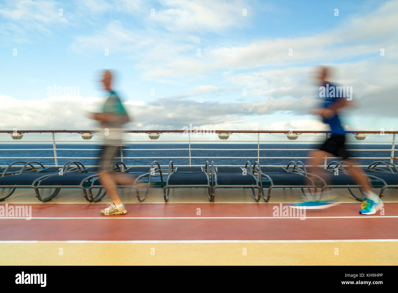 Blurred Joggers on cruise ship running track Stock Photo - Alamy