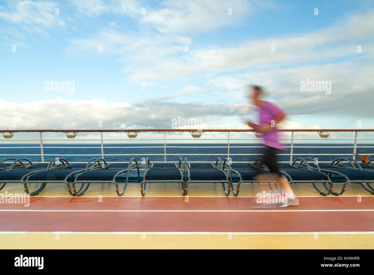 Blurred Joggers on cruise ship running track Stock Photo - Alamy