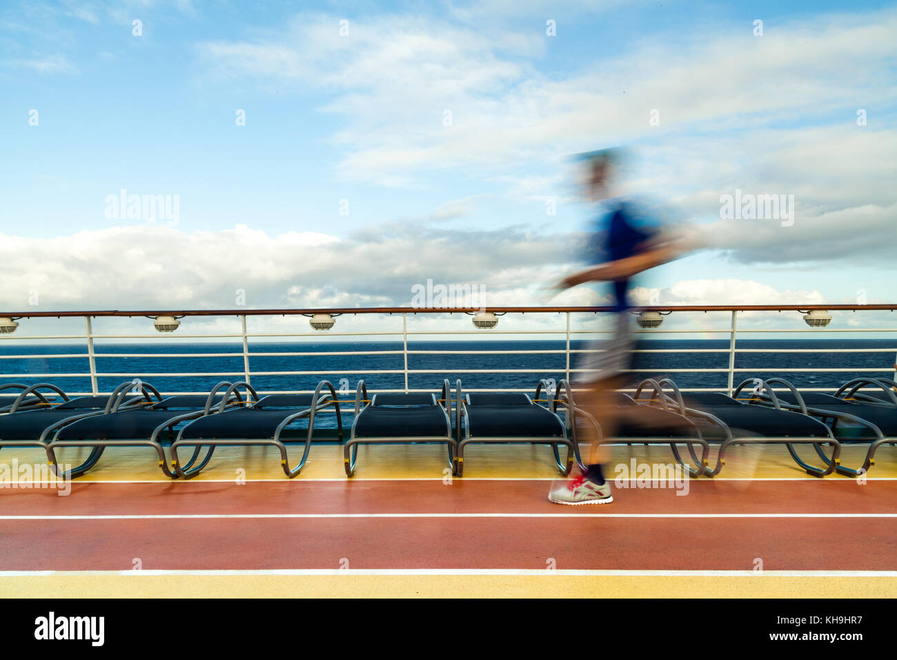 Blurred Joggers on cruise ship running track Stock Photo - Alamy