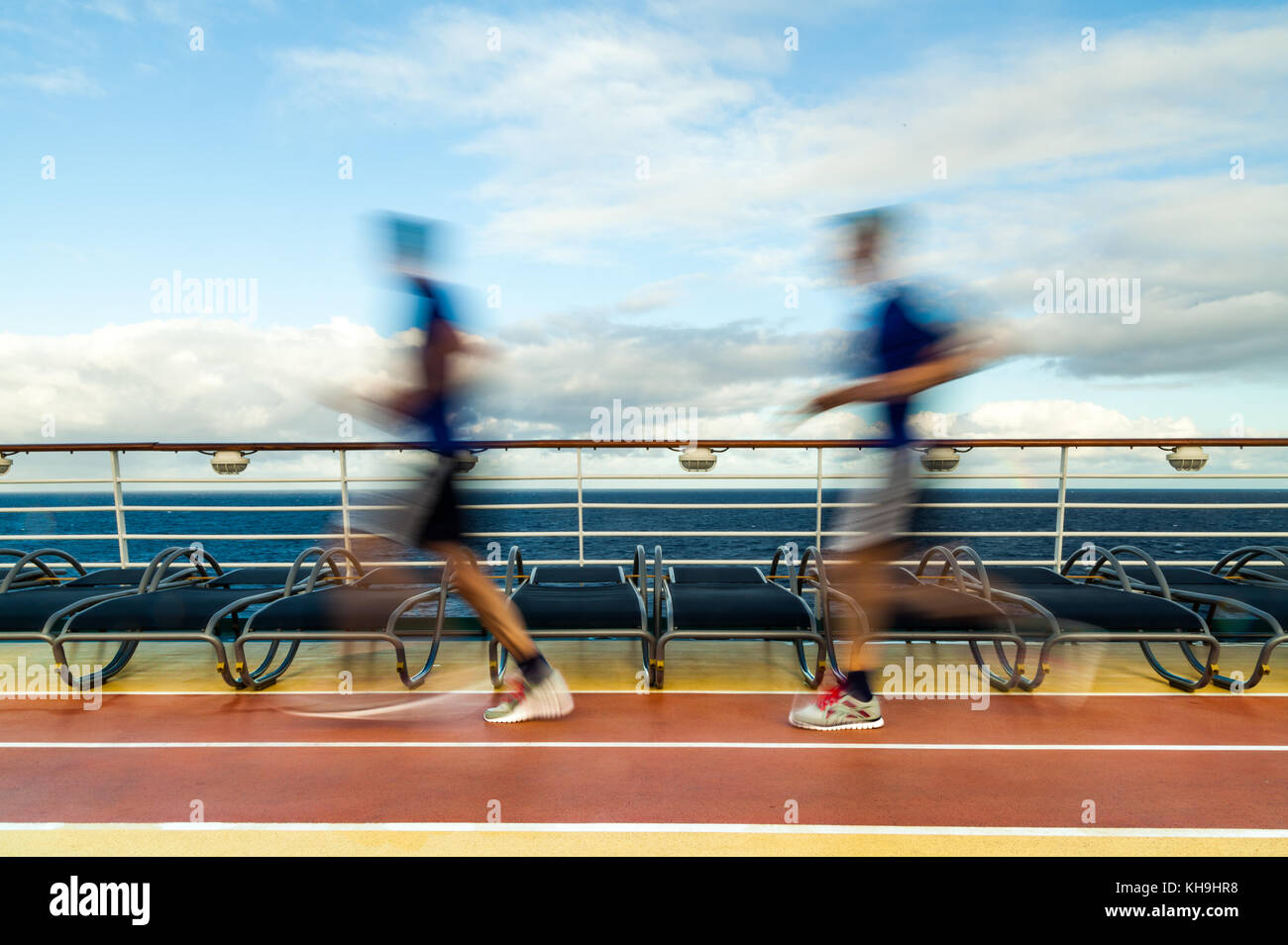 Blurred Joggers on cruise ship running track Stock Photo - Alamy
