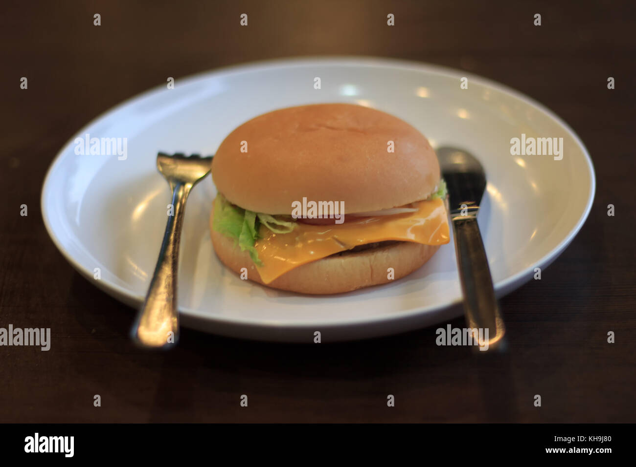 The burger is placed on a white plate select focus, Burger with white ...