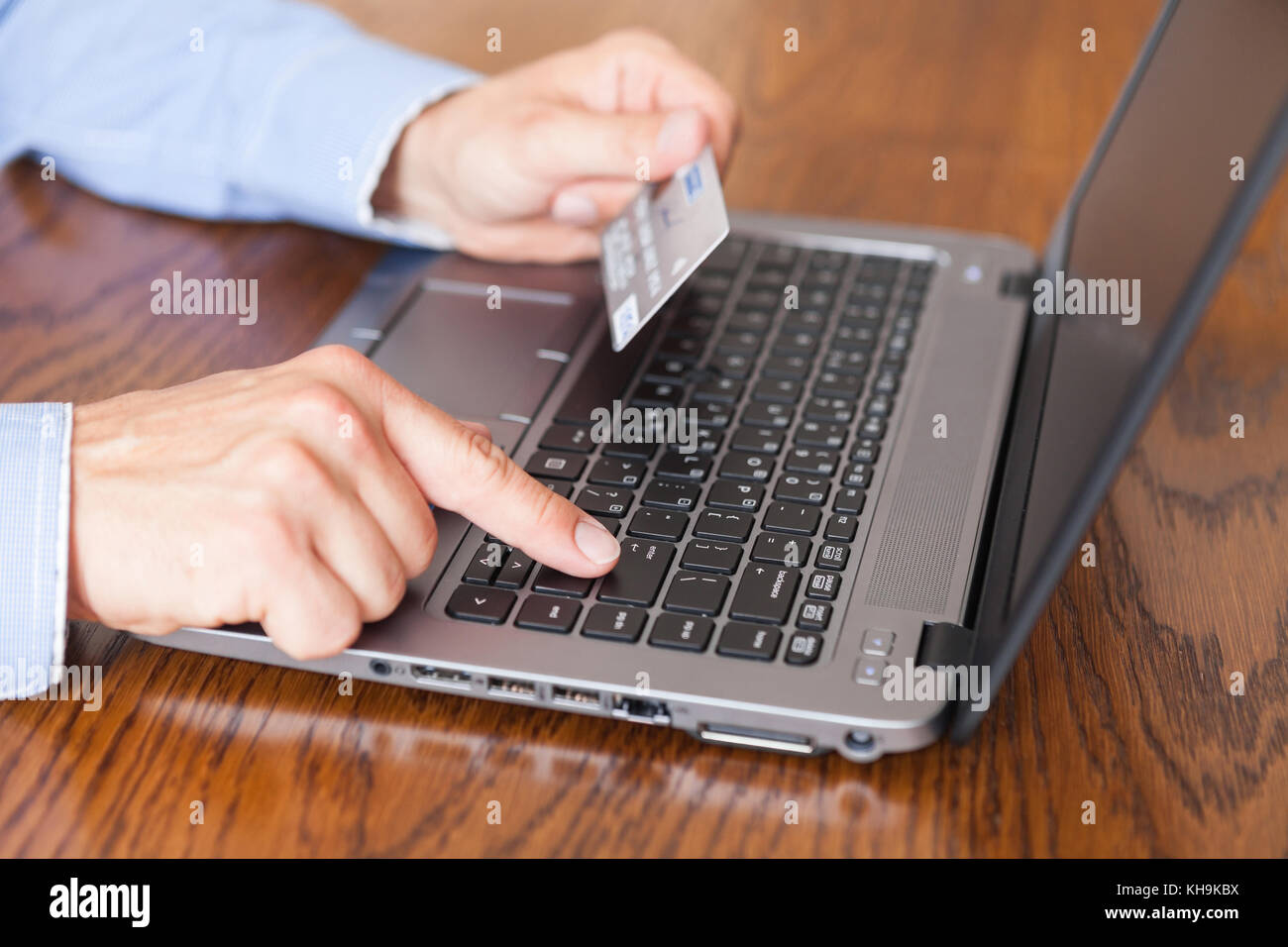 Men's hands holding credit card and using laptop, finger point enter ...