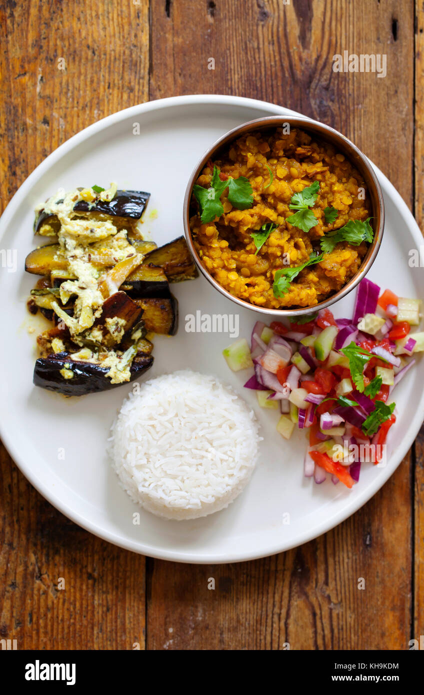 Indian meal with red lentils curry - masoor dal, dahi baingan, rice and ...