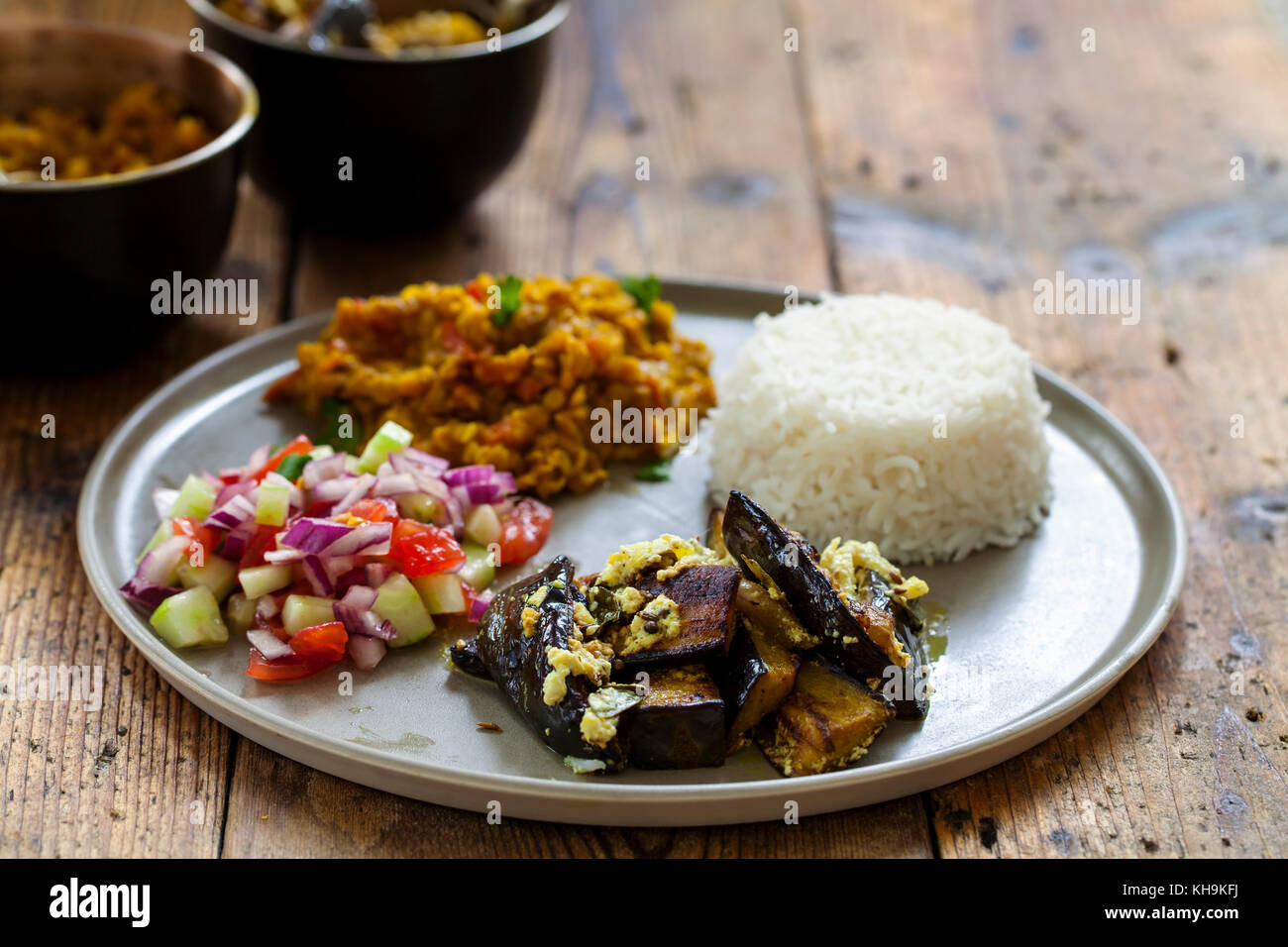 Indian meal with masoor dal - lentil curry, dahi baingan, rice and ...