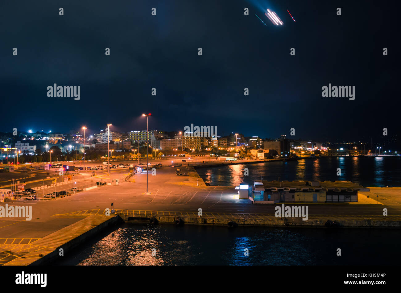 View from the deck of a ferry boat of the port and the city at night ...