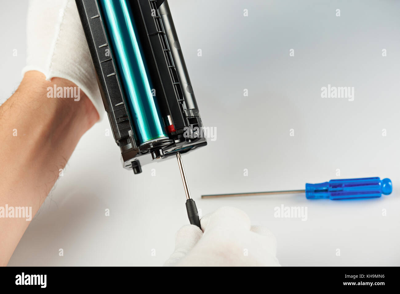 Modern service of repairing printers. Man checking printer catridge ...