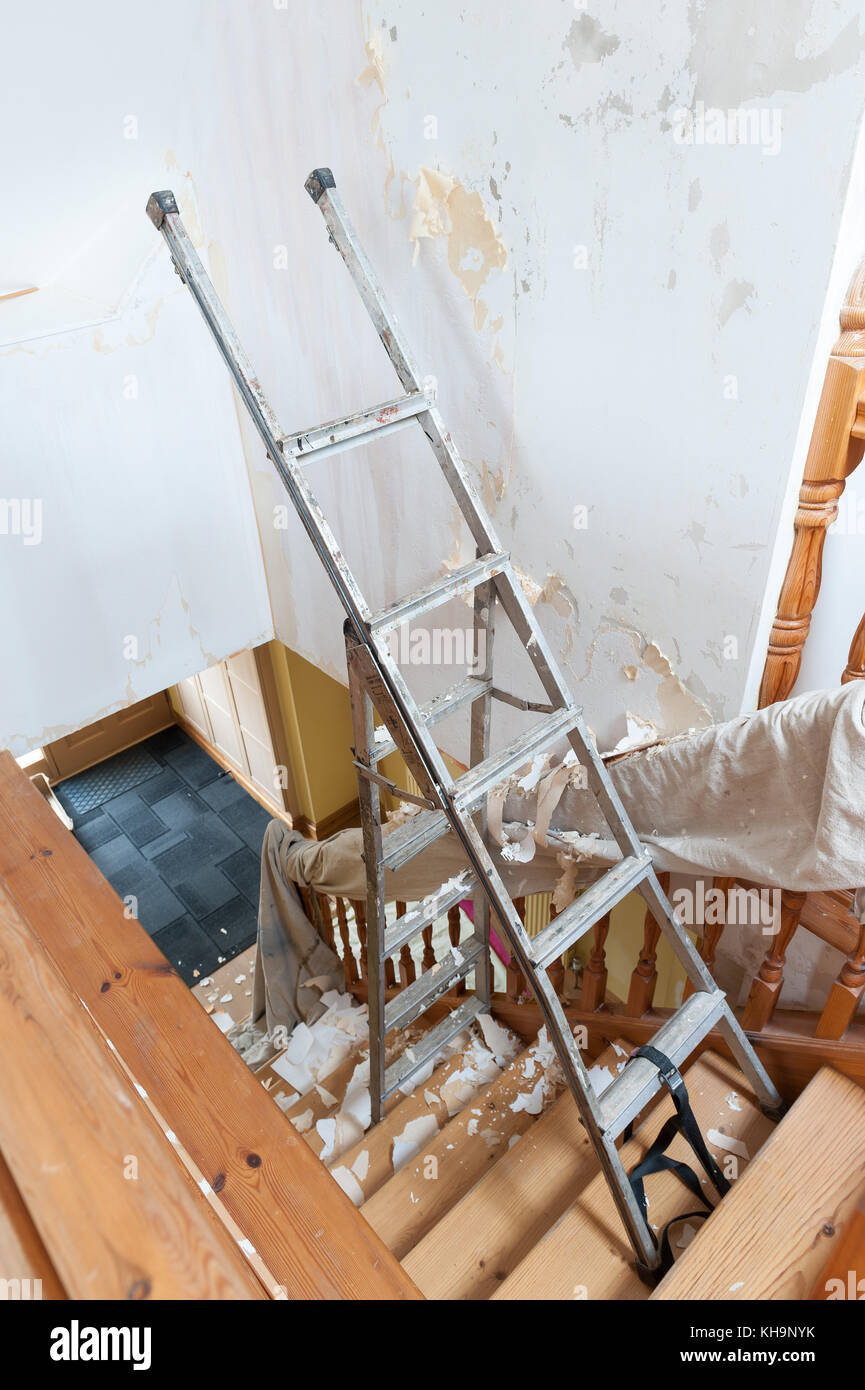 Dangerous tricky position decorating stripping on home stairs on a ...