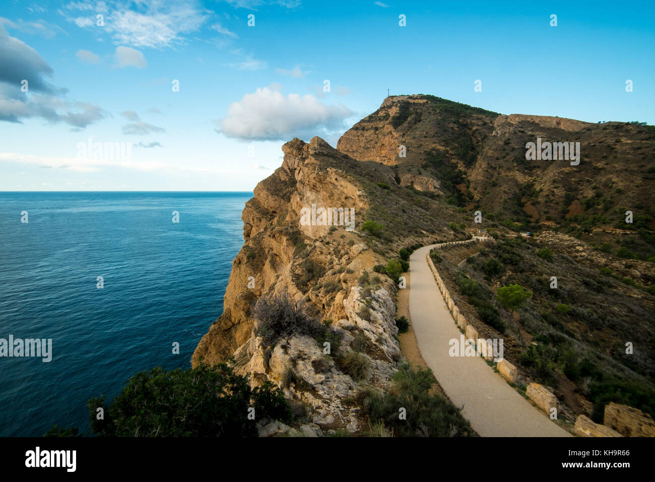 Sierra Helada cliffs and scenic road to its lighthouse overlooking ...