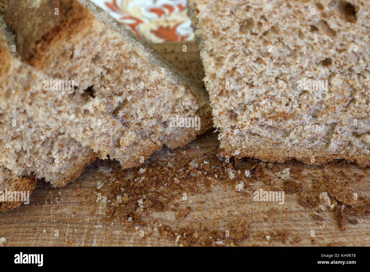 Closeup of whole grain bread cut on a breadboard Stock Photo - Alamy