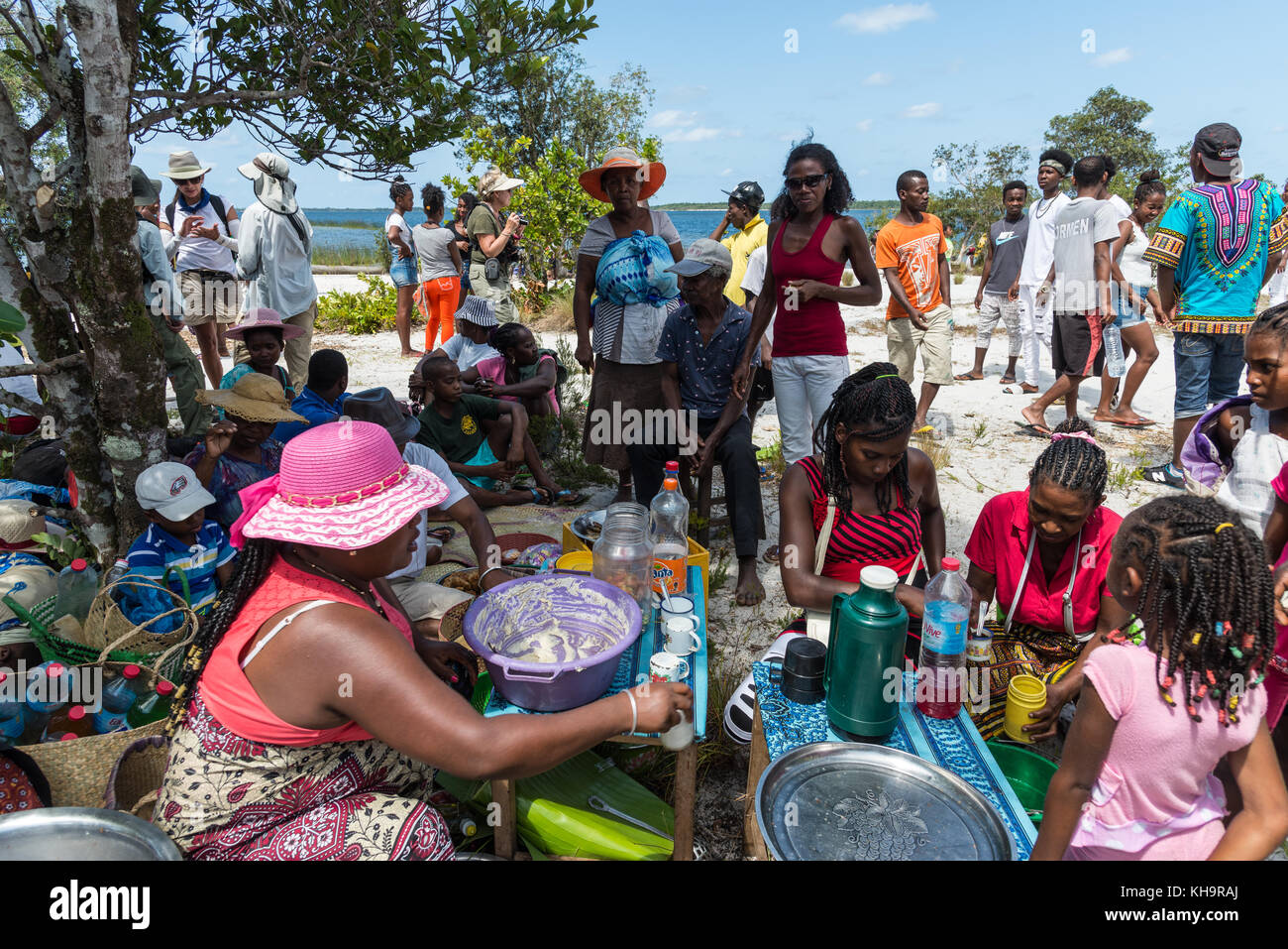 People gather around a food stall at a Zebu sacrifice ceremony, Lake ...