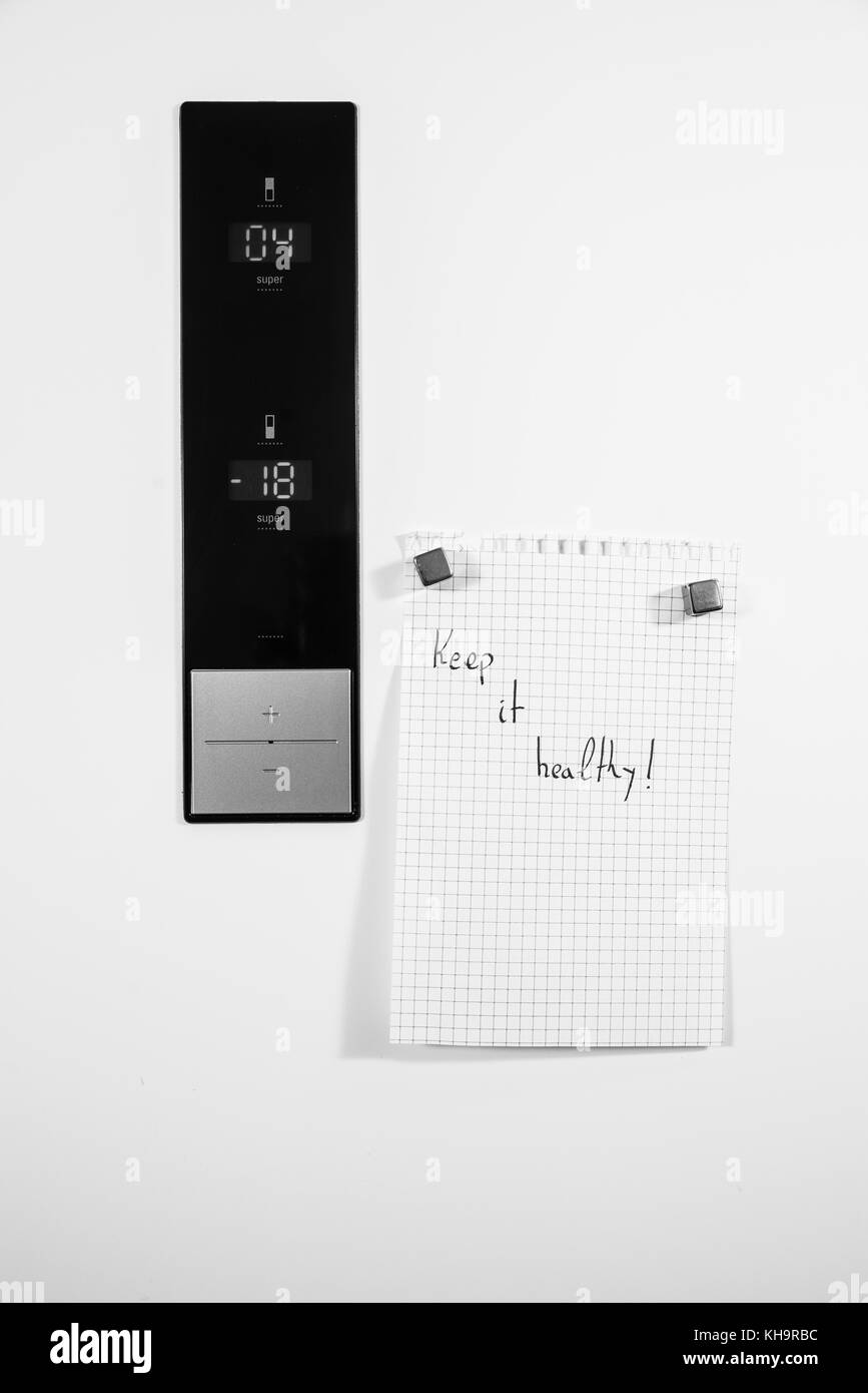 Handwritten note on a fridge door suggesting to only buy healthy food ...