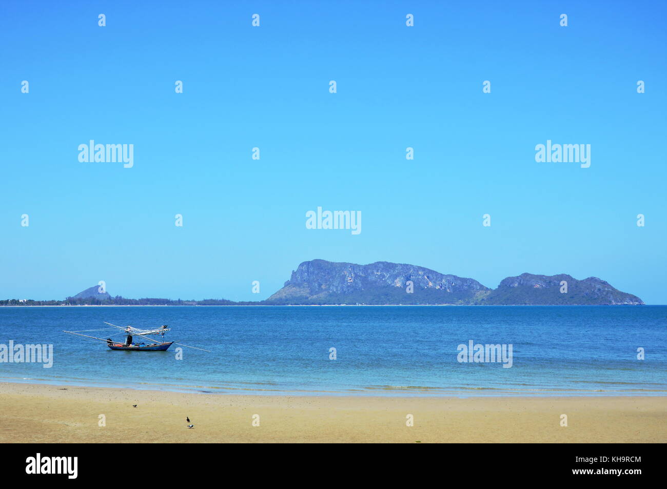 fishery boat floating on beach in sunny day Stock Photo - Alamy