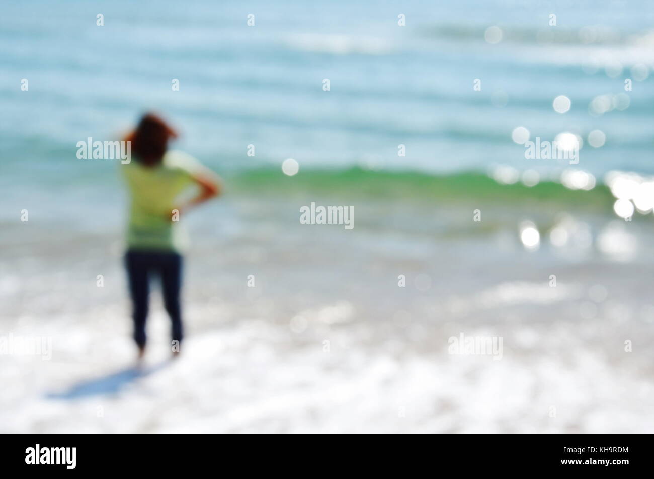 blurry of woman looking to sea view on beach background Stock Photo - Alamy