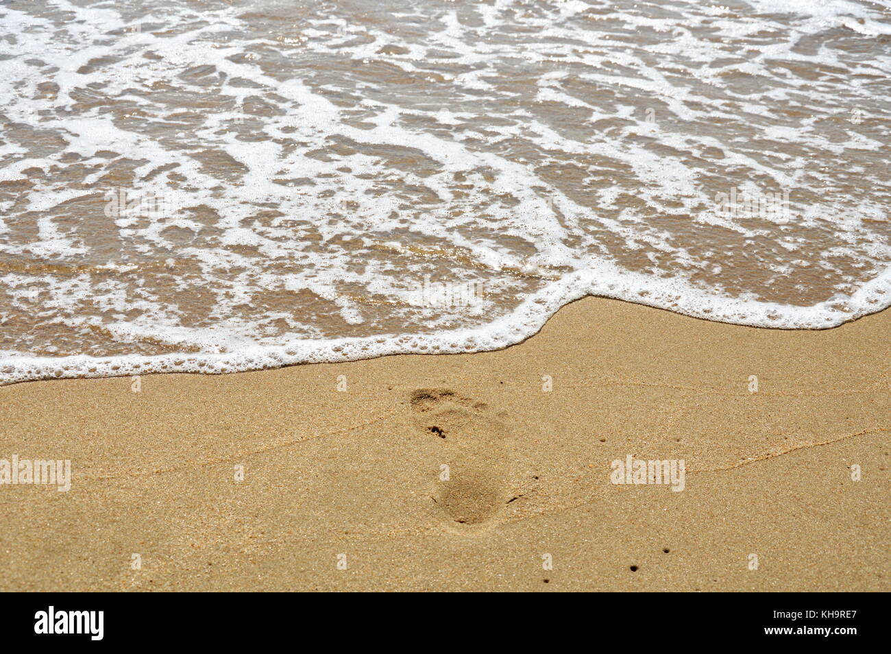 sea water flow to foot step on the beach Stock Photo - Alamy