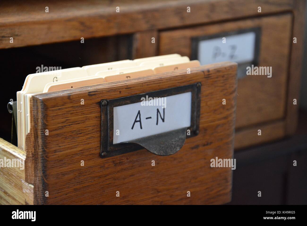 A handwritten antique person library paper and wooden card catalog ...