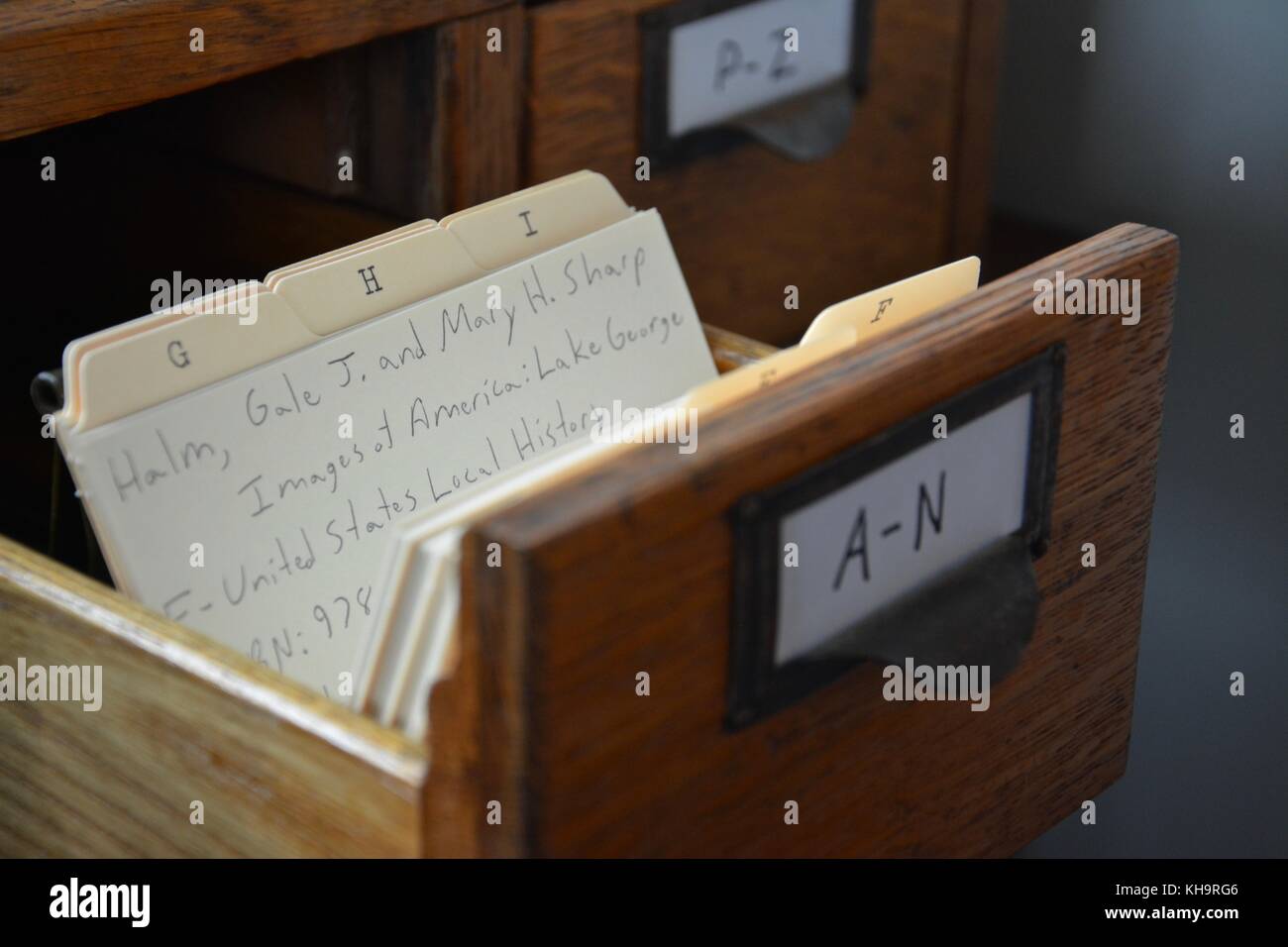 A handwritten antique person library paper and wooden card catalog ...
