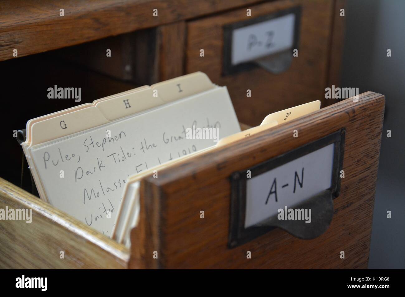 A handwritten antique person library paper and wooden card catalog ...