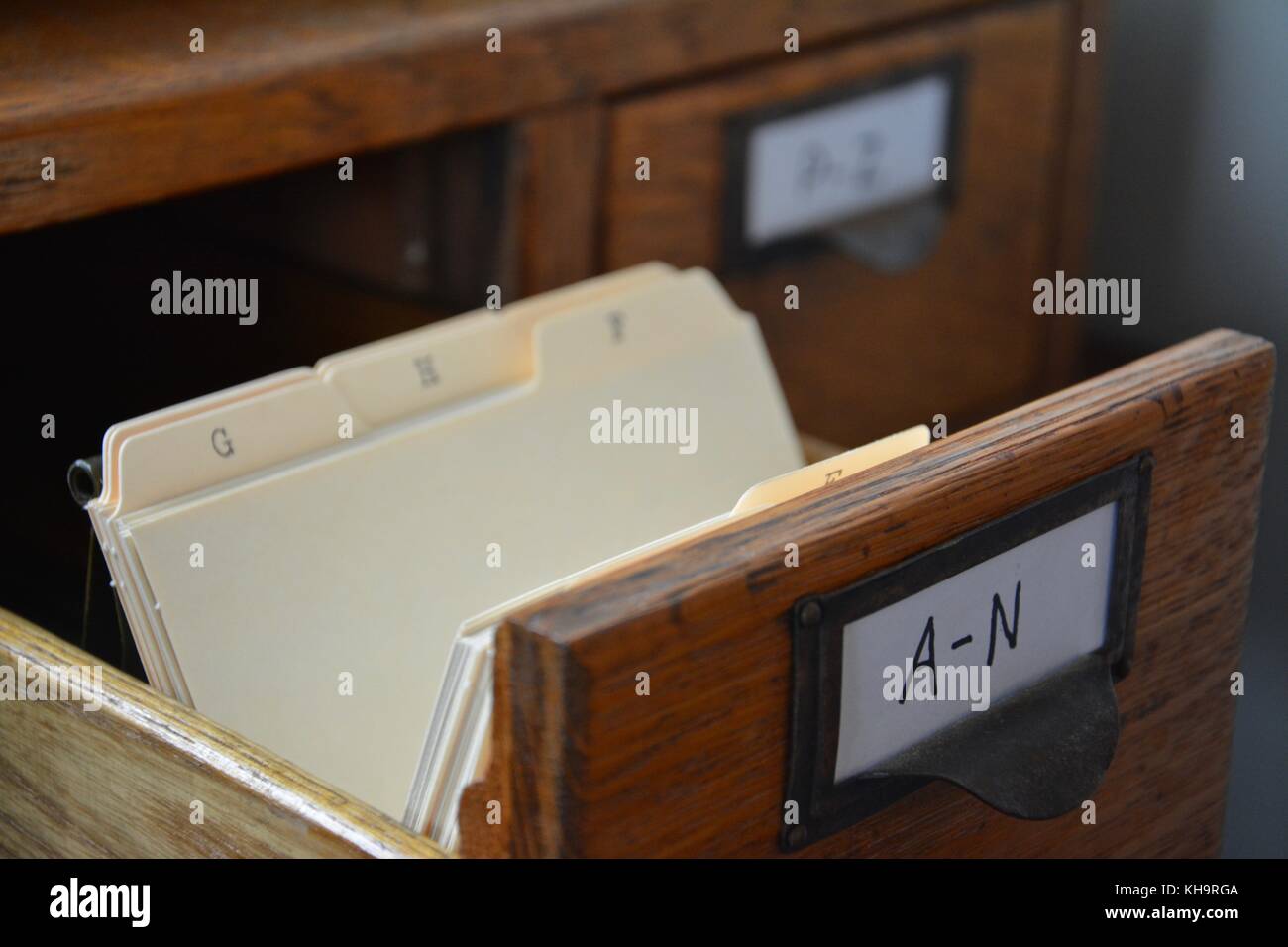 A handwritten antique person library paper and wooden card catalog ...