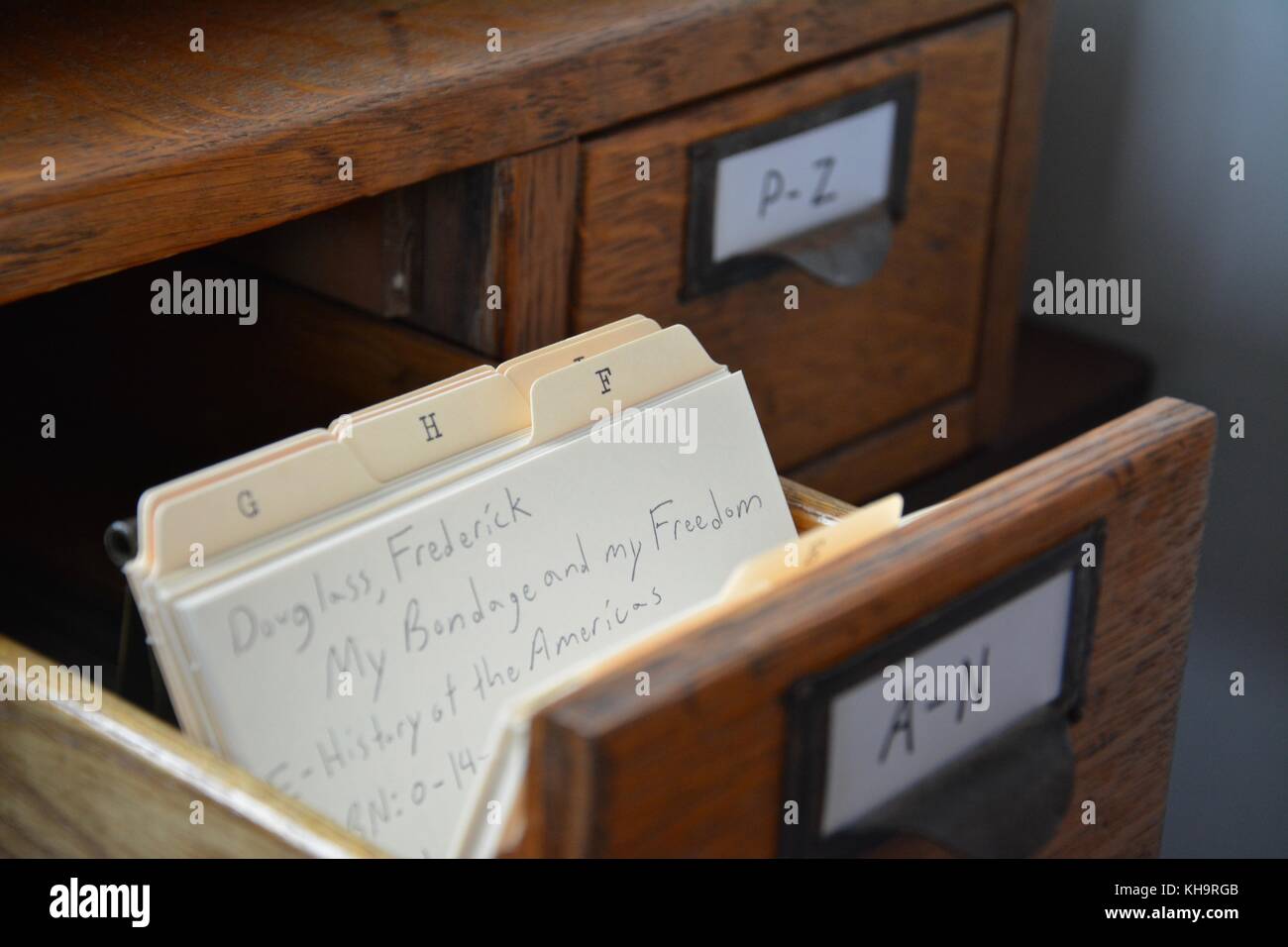 A handwritten antique person library paper and wooden card catalog ...