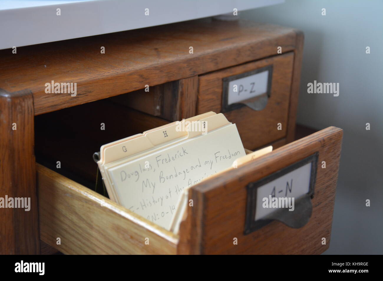 A handwritten antique person library paper and wooden card catalog ...