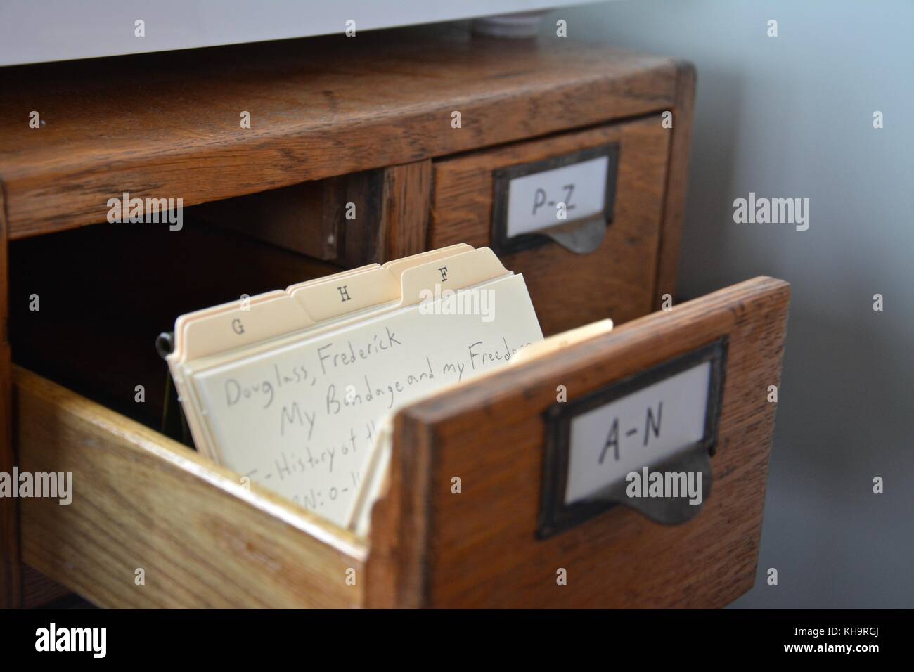 A handwritten antique person library paper and wooden card catalog ...