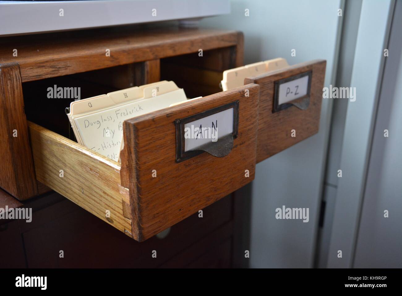 A handwritten antique person library paper and wooden card catalog ...