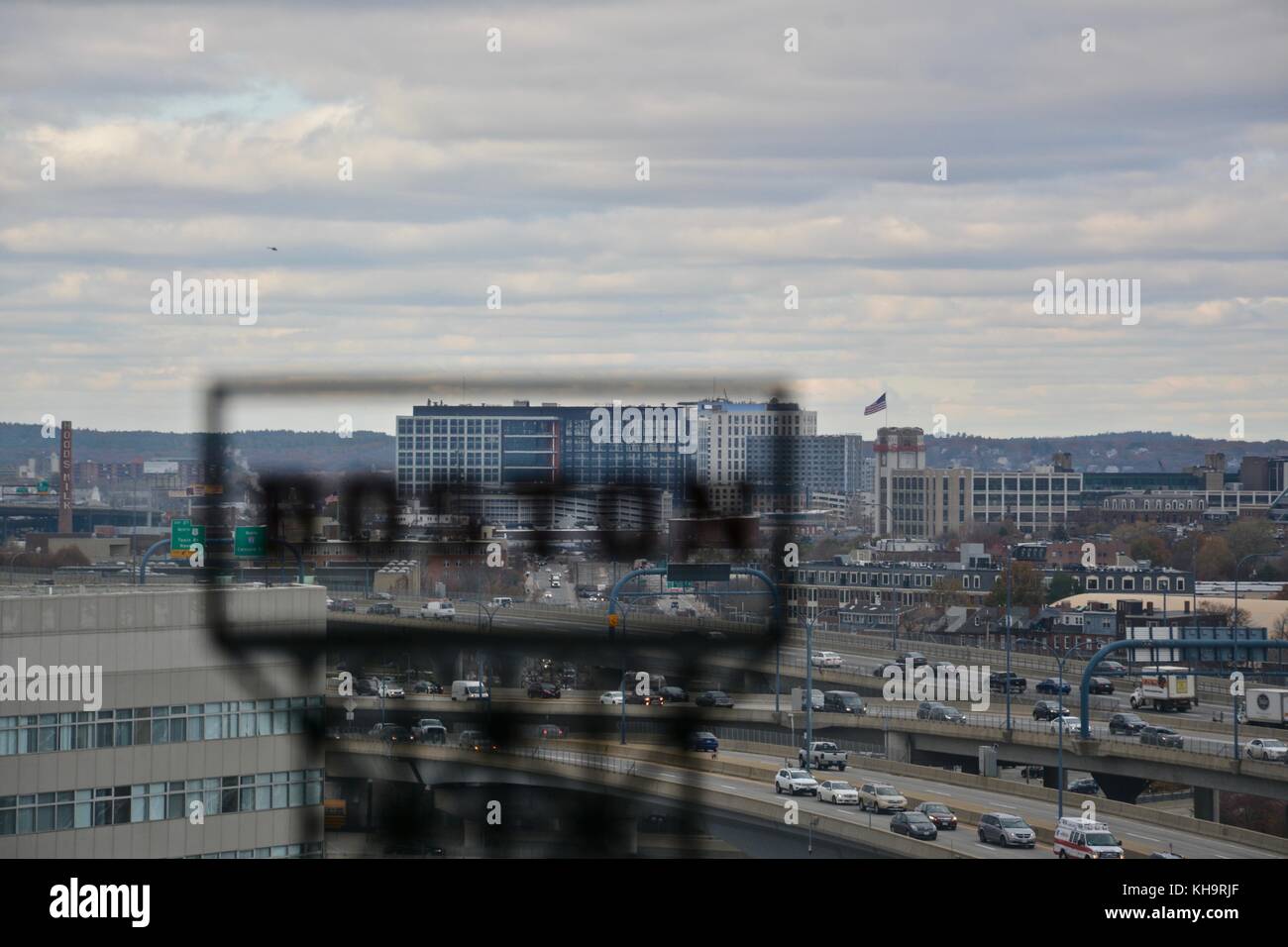 A "Boston" billboard sign macro shot with the Boston cityscape behind ...