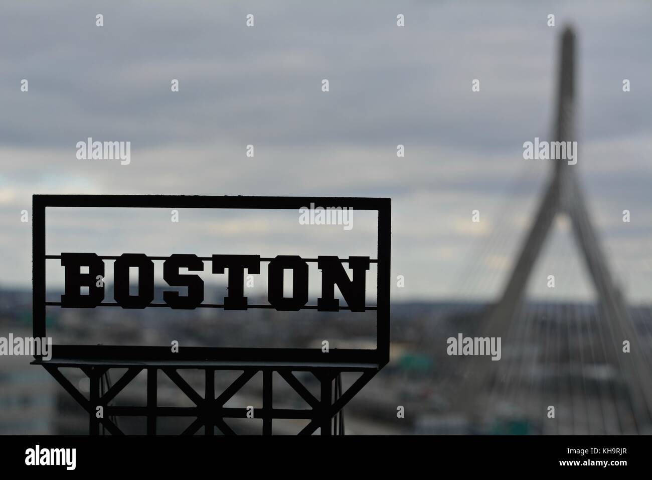 A "Boston" billboard sign macro shot with the Boston cityscape behind ...