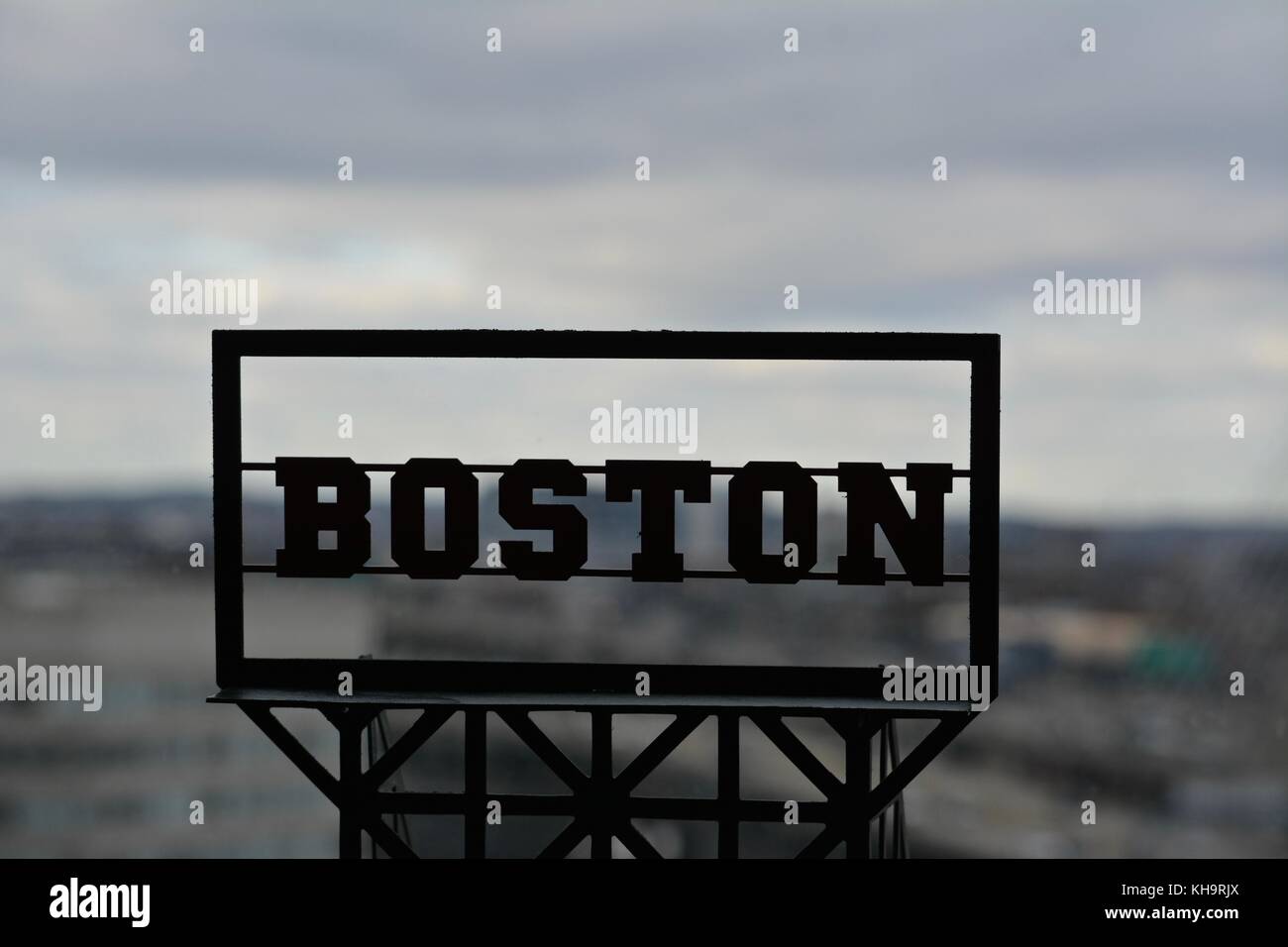 A "Boston" billboard sign macro shot with the Boston cityscape behind ...