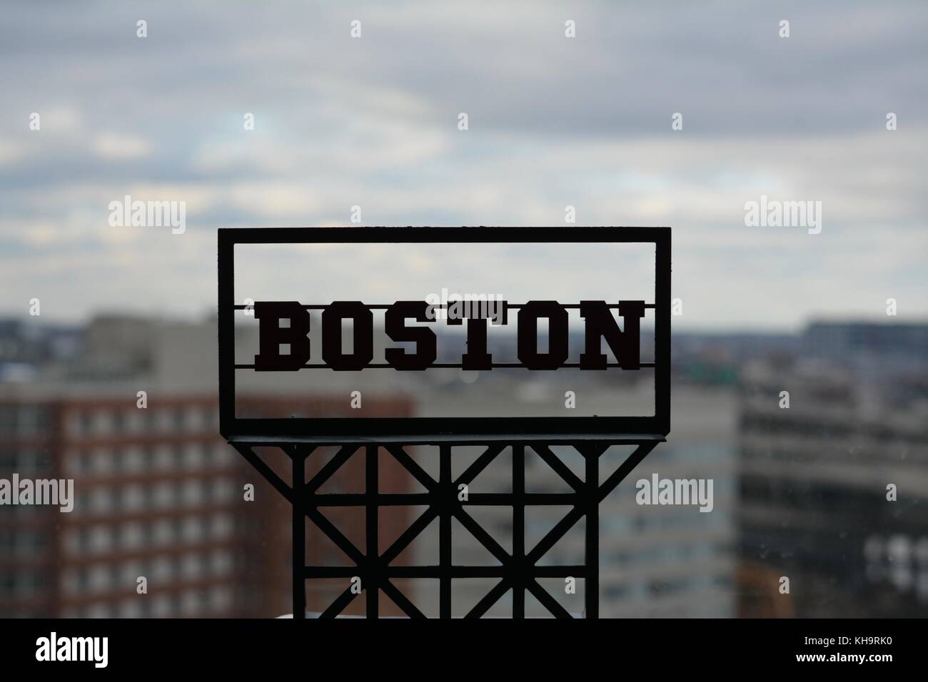 A "Boston" billboard sign macro shot with the Boston cityscape behind ...