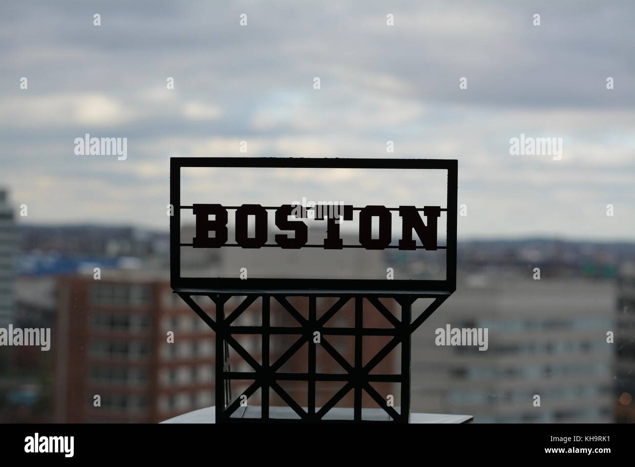 A "Boston" billboard sign macro shot with the Boston cityscape behind ...