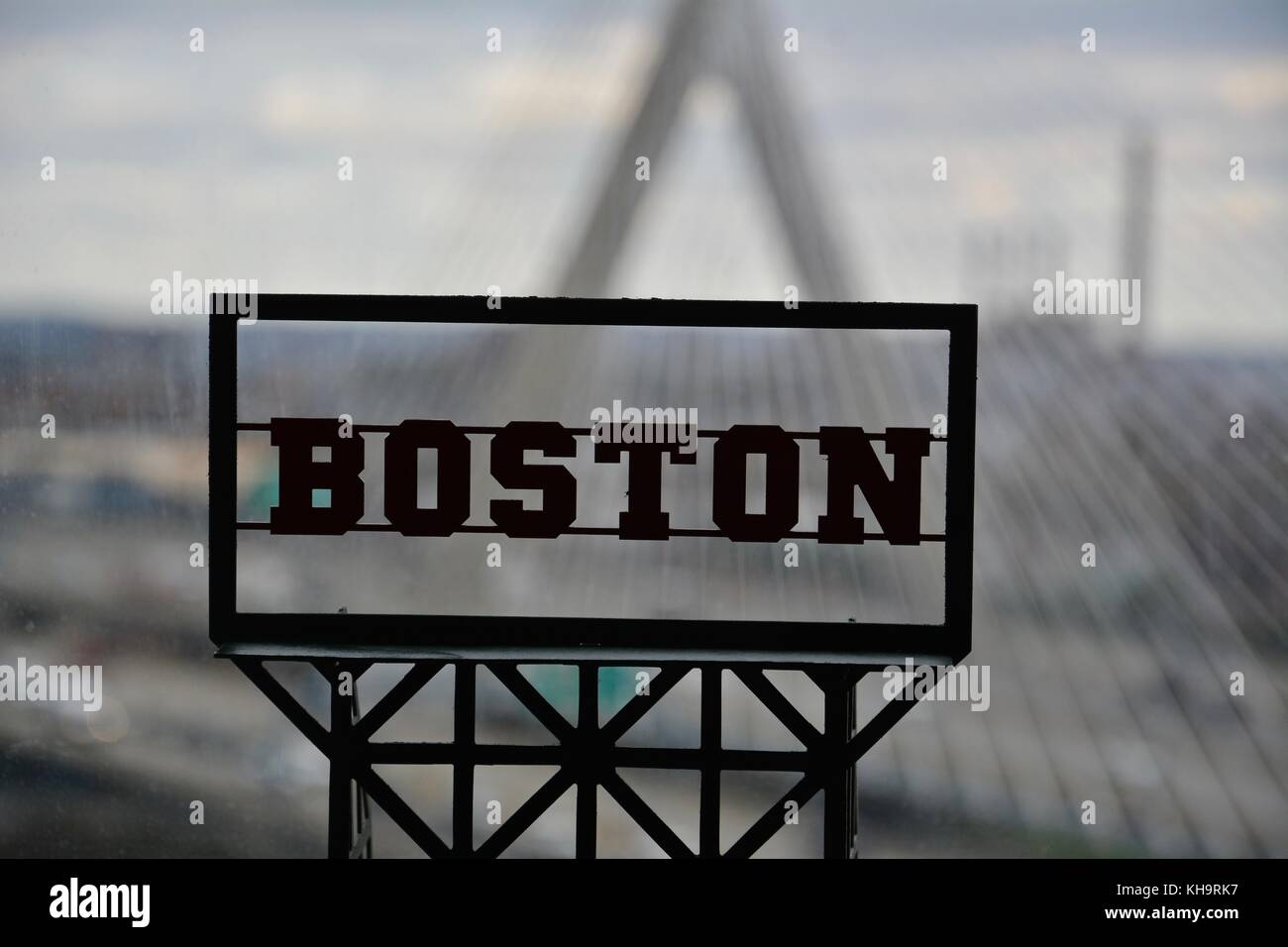A "Boston" billboard sign macro shot with the Boston cityscape behind ...