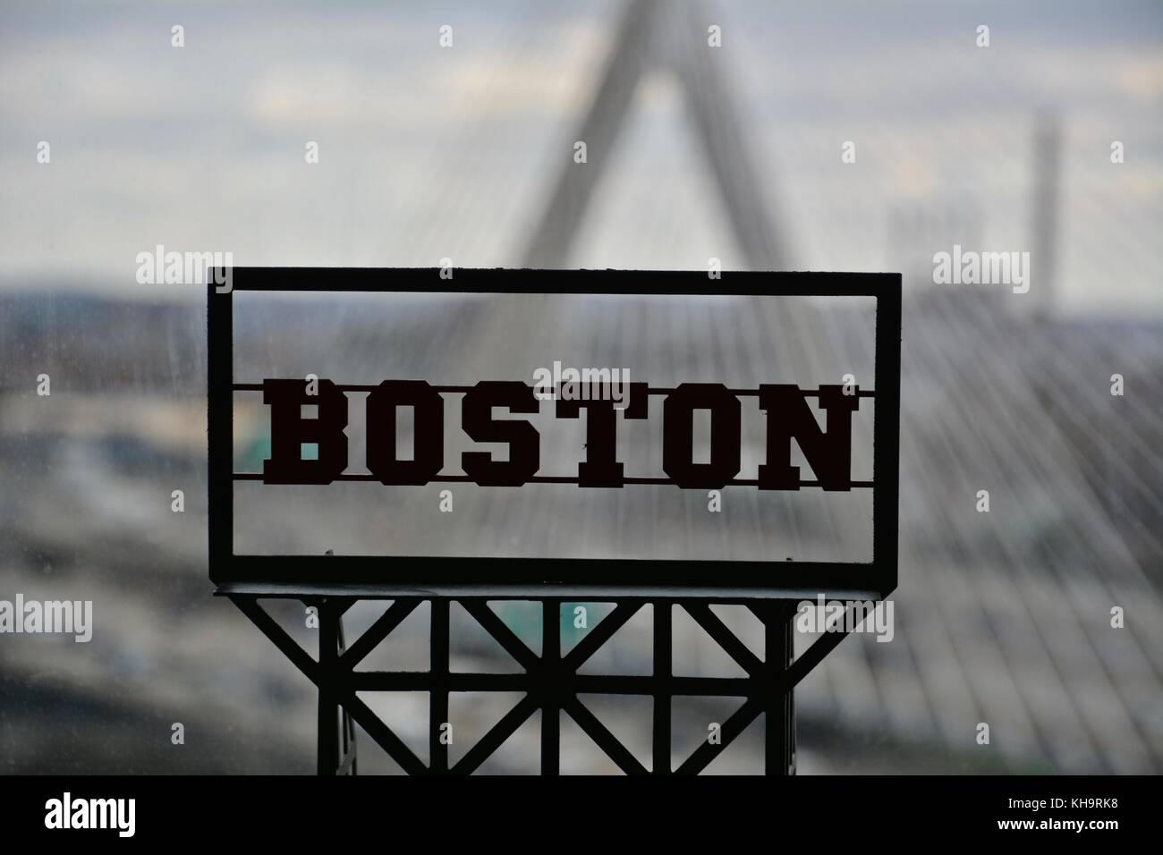 A "Boston" billboard sign macro shot with the Boston cityscape behind ...