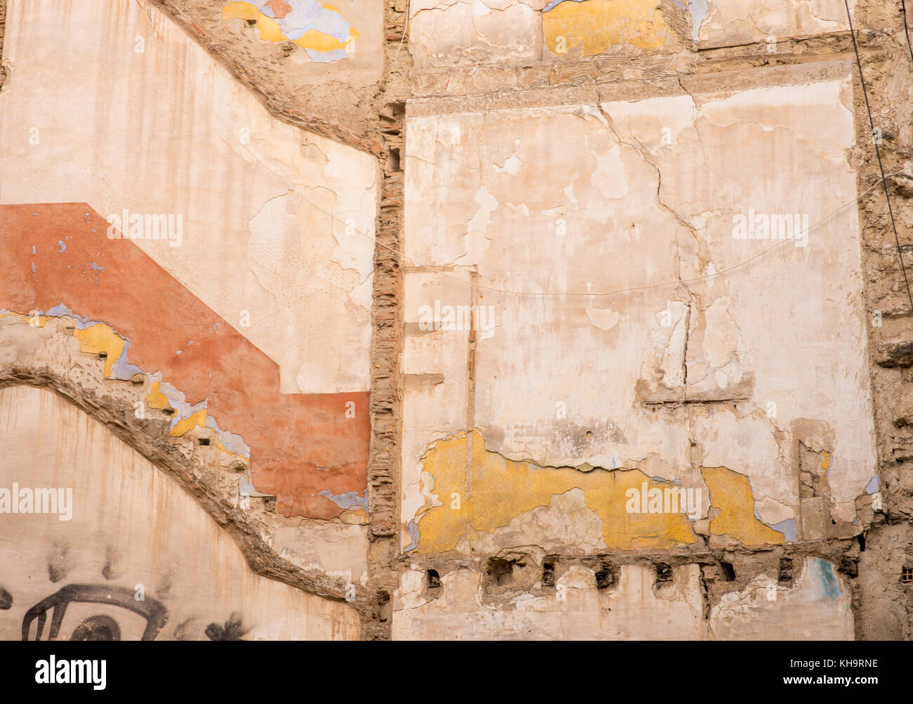 Old wall of a ruined building displaying several colours and textures ...