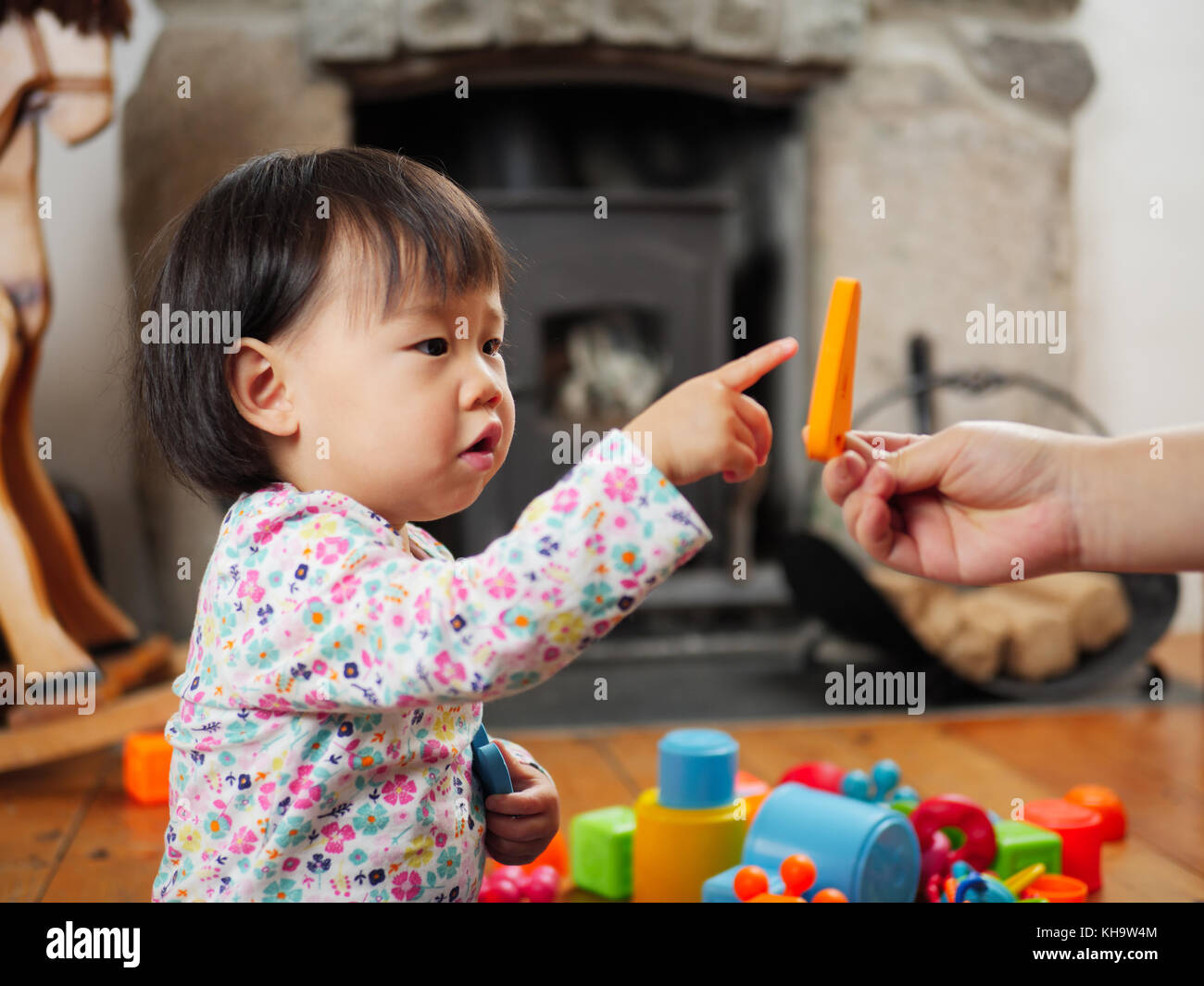baby girl playing alphabet blocks at home Stock Photo - Alamy