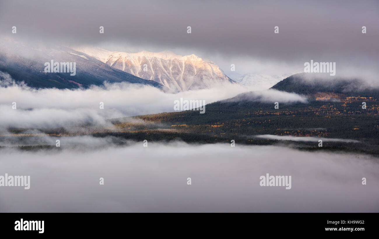Sunrise and morning mist over Columbia Valley and snowy mountains ...