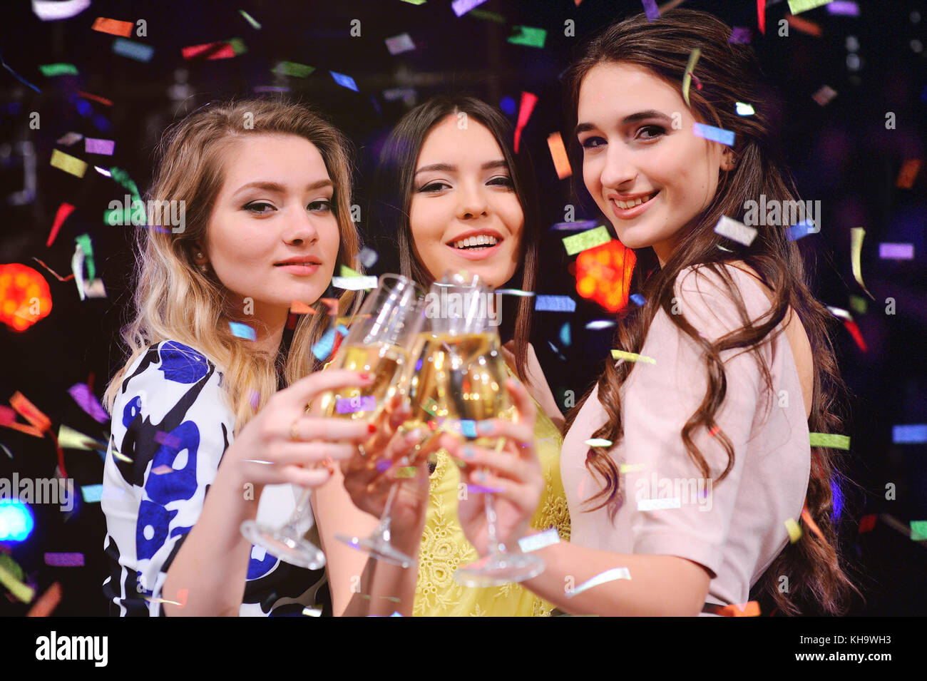 three pretty young girls with glasses of champagne Stock Photo - Alamy