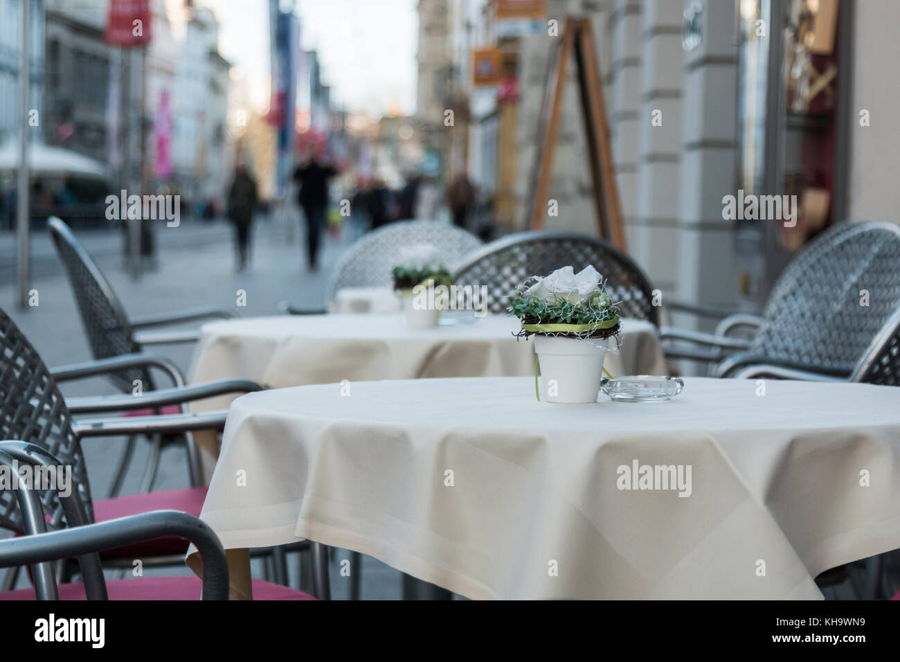 Empty tables on the street Stock Photo - Alamy