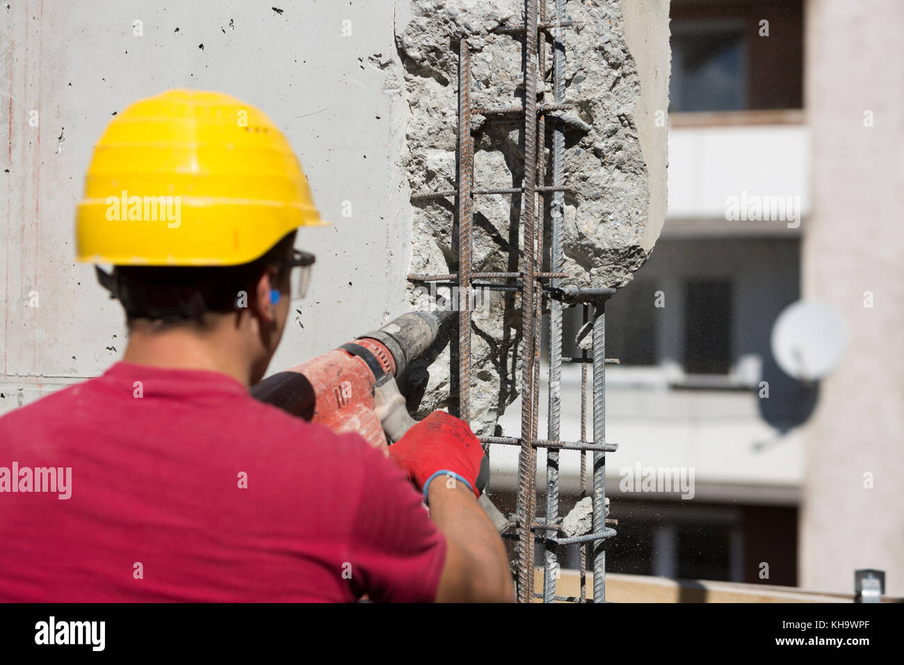 Construction worker using a drilling power tool Stock Photo - Alamy
